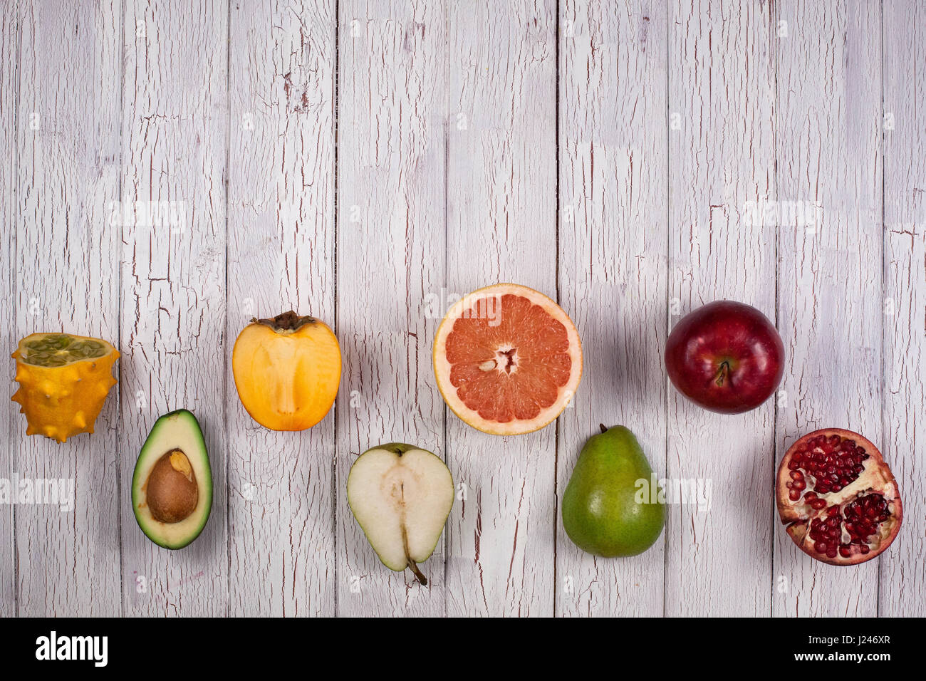 Composition of fruits in a checkerboard pattern placed on a white or ...