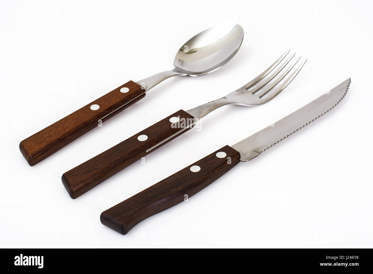 Cutlery with wooden handles on white background. Studio Photo Stock ...
