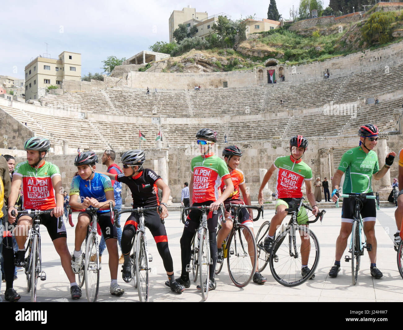 Cyclists stand in the historical Roman amphitheatre in Amman, Jordan ...