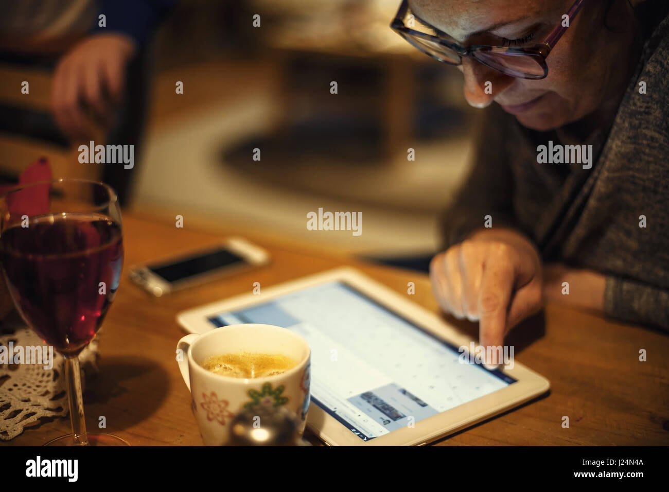 Portrait of a woman reading and searching something on notebook Stock ...