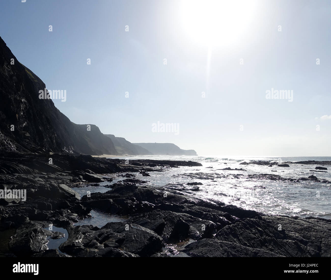 Beach scene in bright winter sun Stock Photo - Alamy