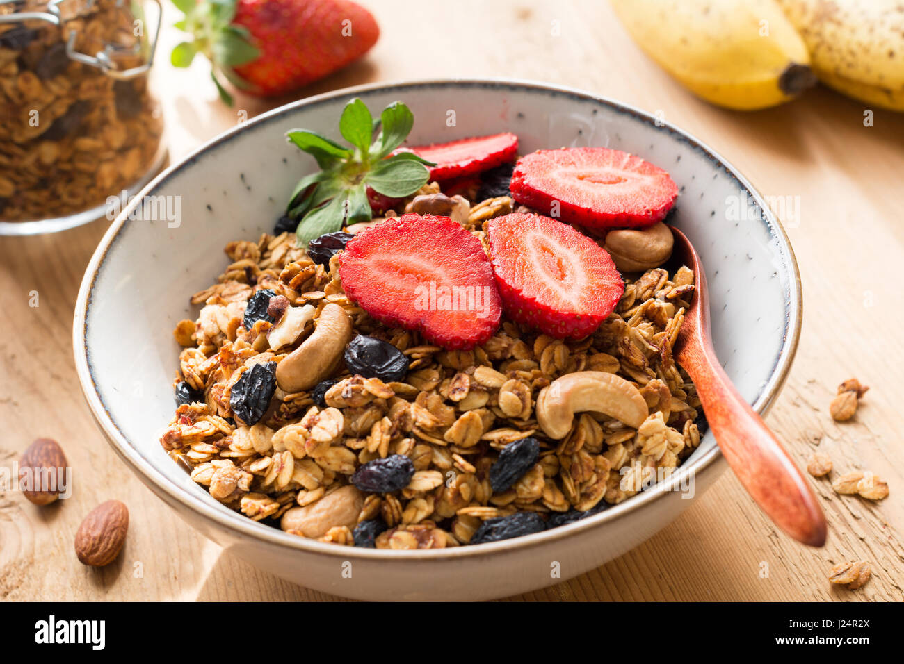 Granola with fresh strawberries, dry fruits and nuts in bowl. Healthy ...