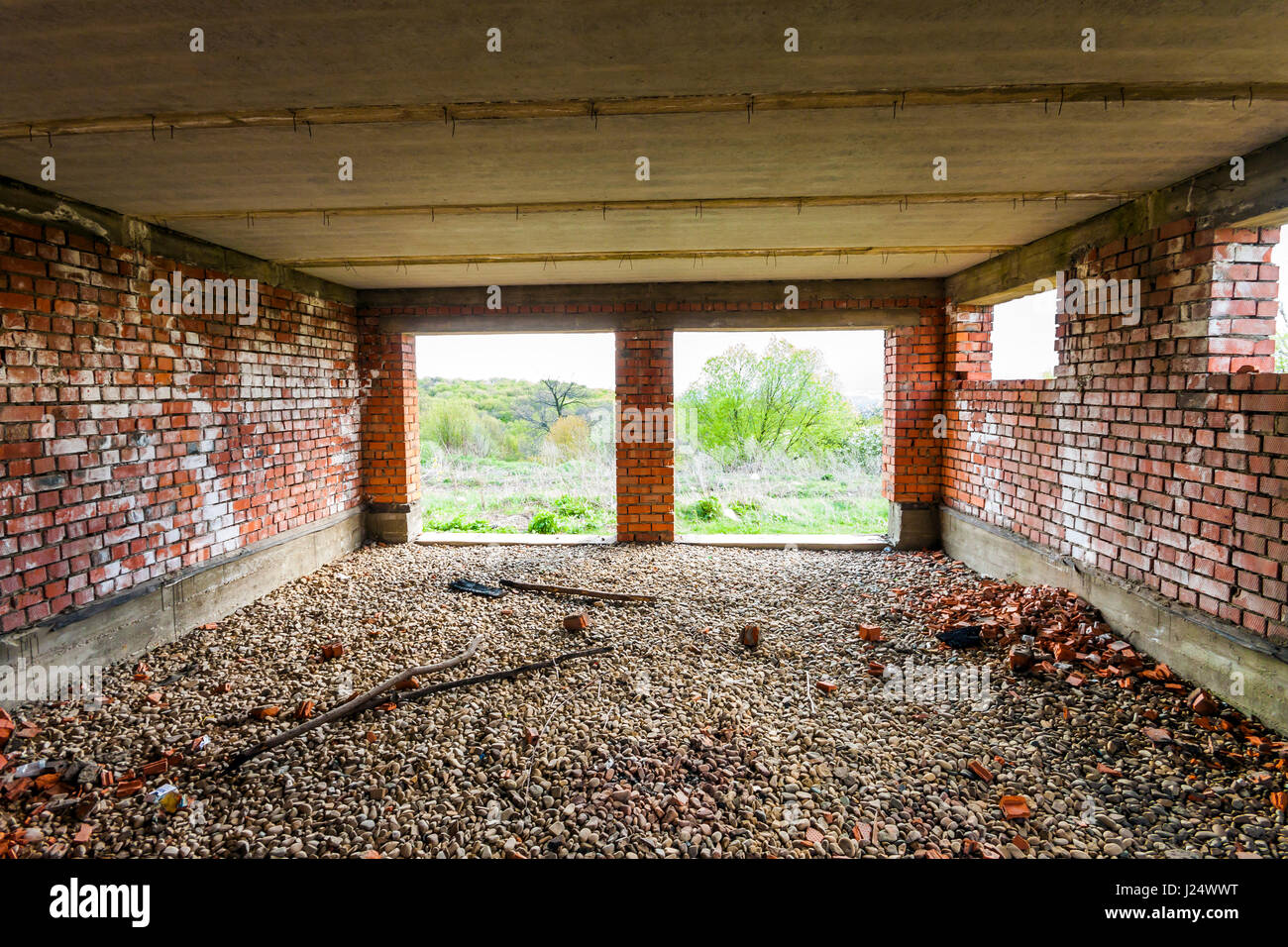 Interior of an old building under construction. Orange brick walls in a ...