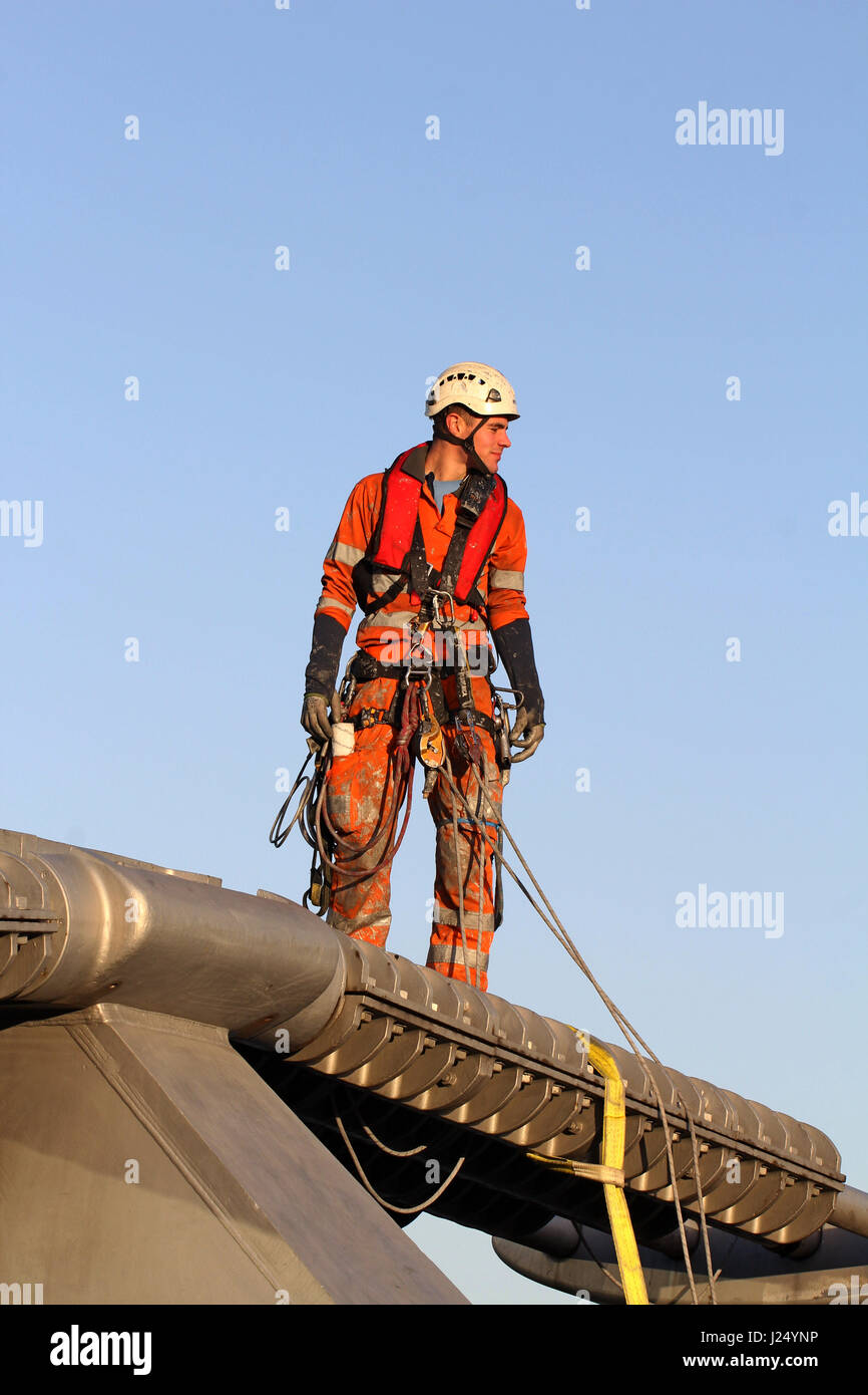 A bridge engineer, wearing a safety harness, on top of the Millennium ...