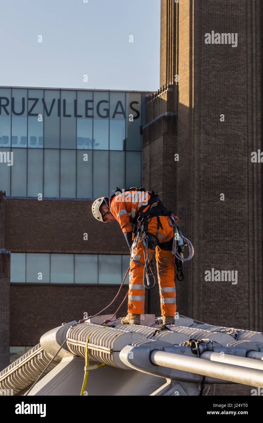 Bridge worker, wearing a safety harness, standing on the Millennium ...