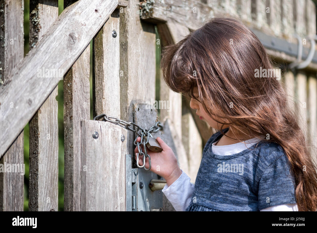 Girl by wooden gate hi-res stock photography and images - Alamy