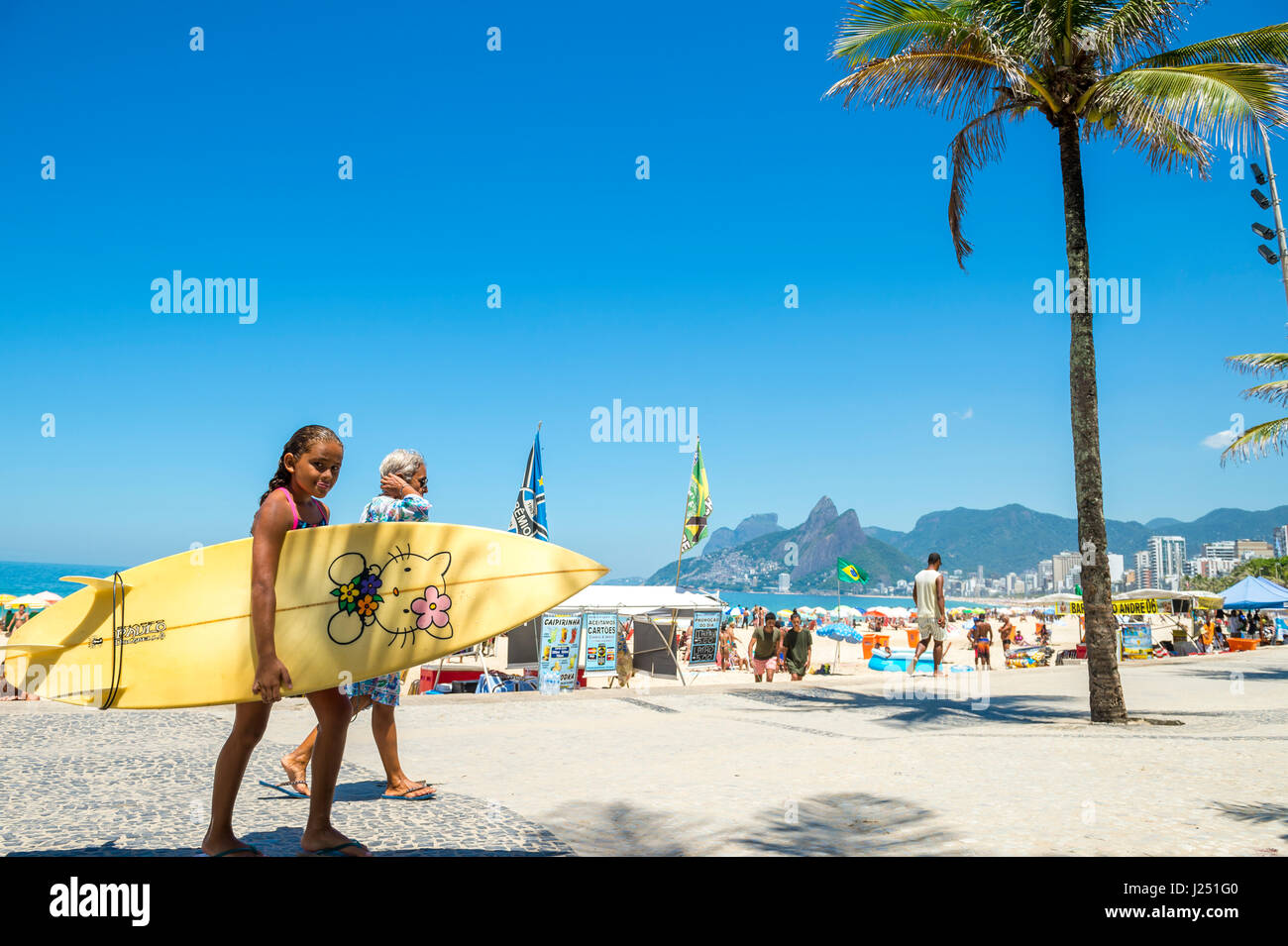 RIO DE JANEIRO - FEBRUARY 17, 2017: Young Brazilian surfer walks with ...