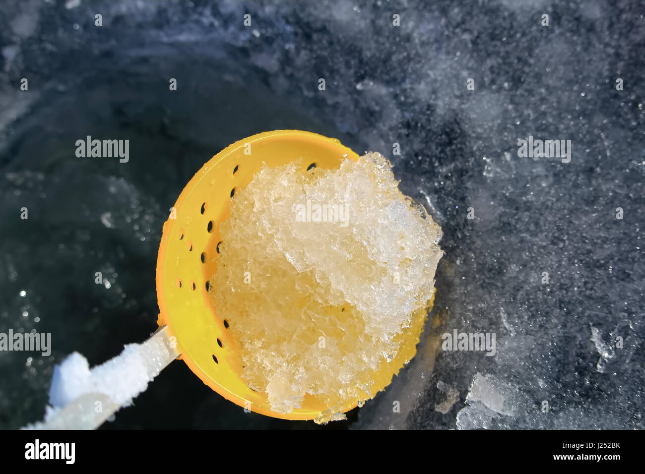 Scooping Out Slush from a Freshly Dug Hole Stock Photo - Alamy