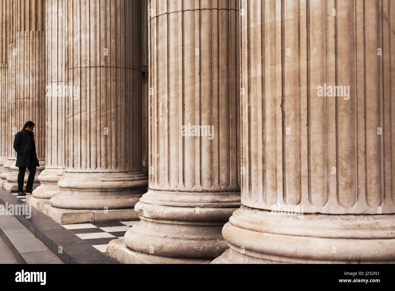 A person by columns of St Paul's Cathedral Stock Photo - Alamy