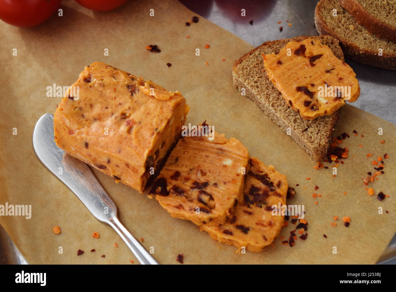 Homemade butter with sun-dried tomatoes for spreads on a backing paper ...