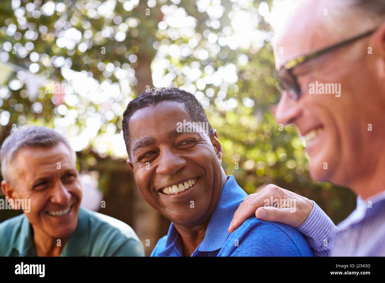 Middle aged friends socializing outdoors hi-res stock photography and ...