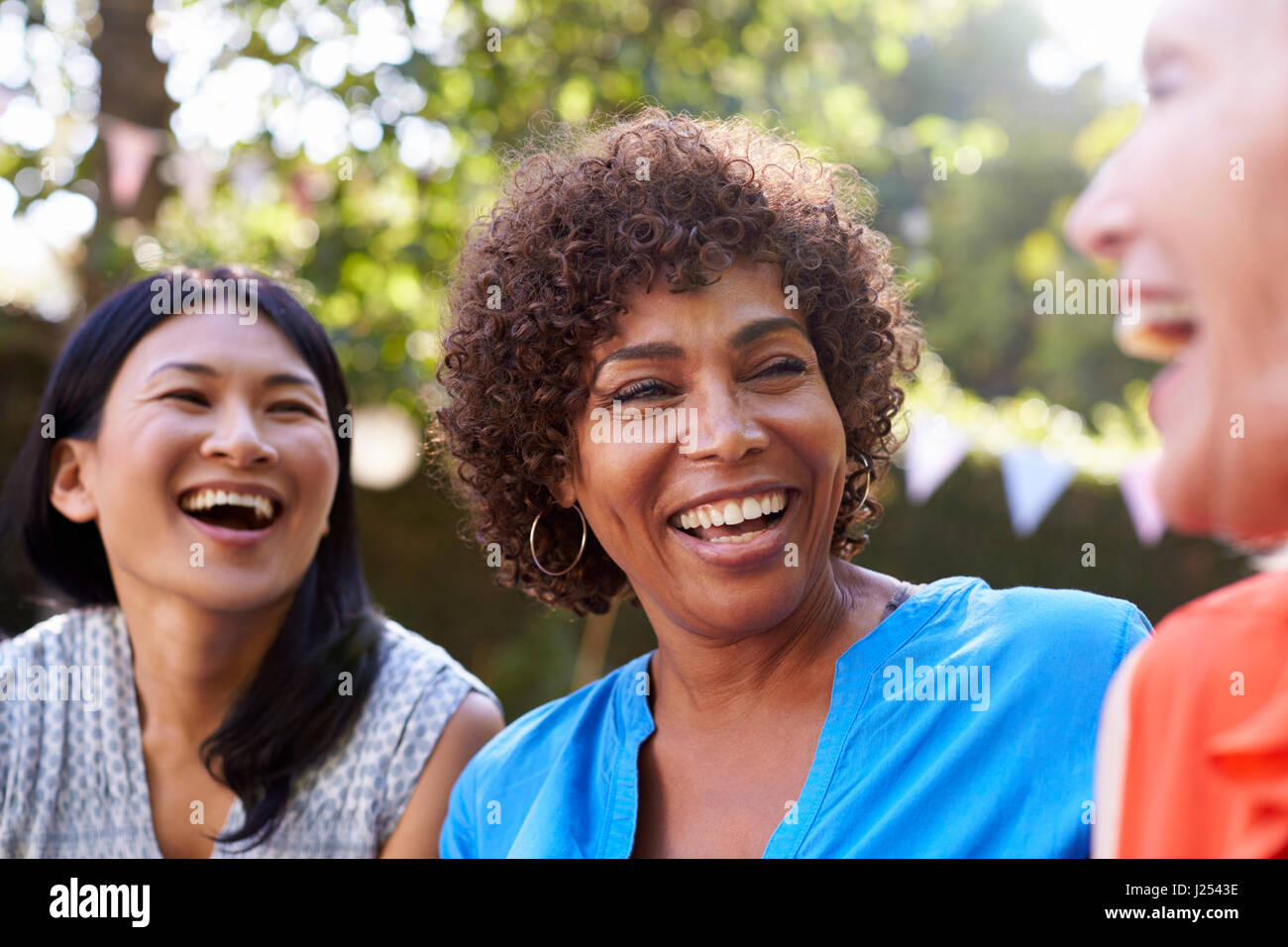 Mature Female Friends Socializing In Backyard Together Stock Photo - Alamy