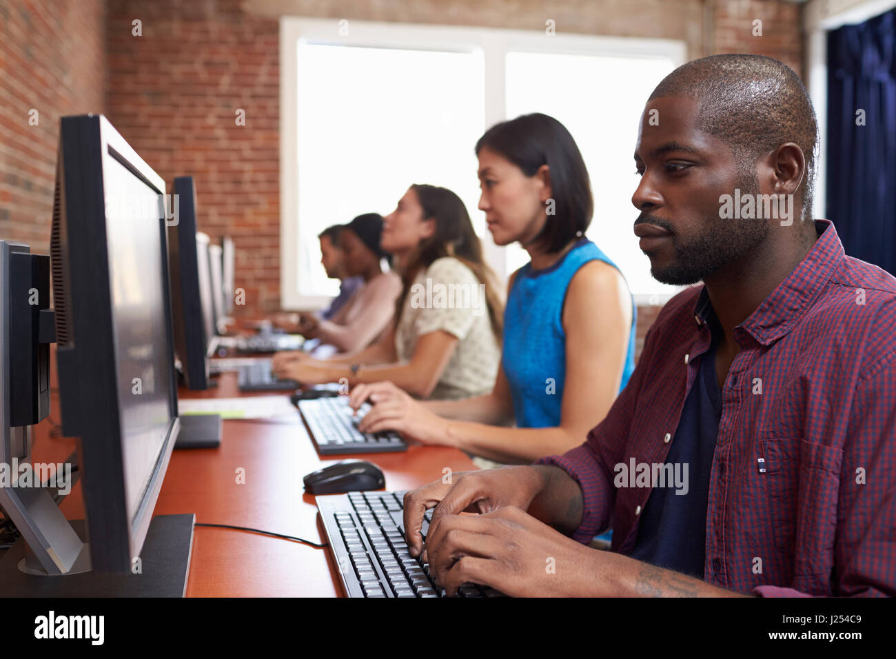 Asian black women staff working computers hi-res stock photography and ...