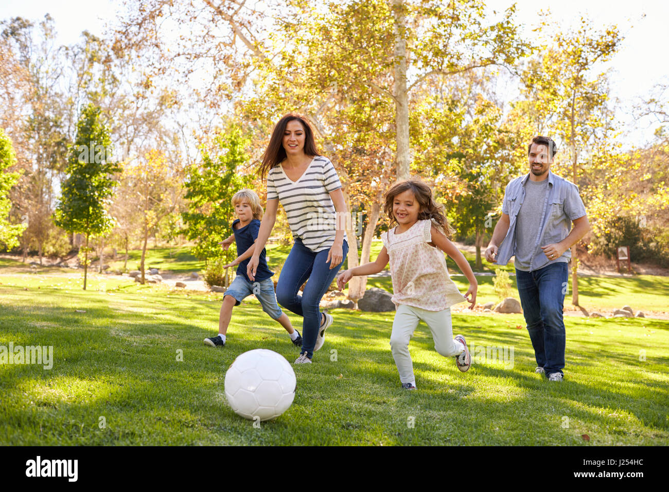 Family Playing Soccer In Park Together Stock Photo - Alamy