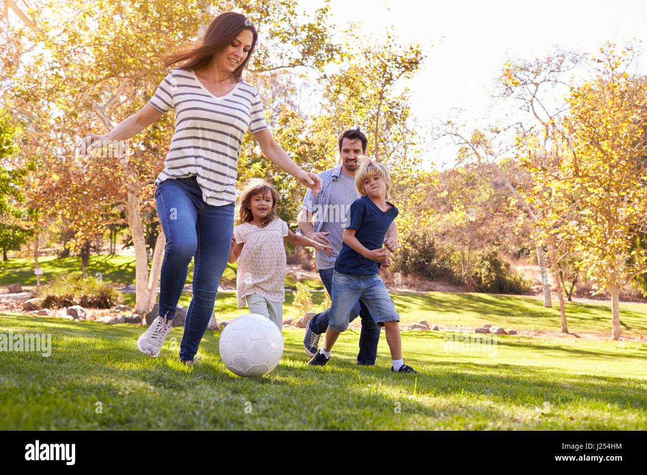 Family Playing Soccer In Park Together Stock Photo - Alamy