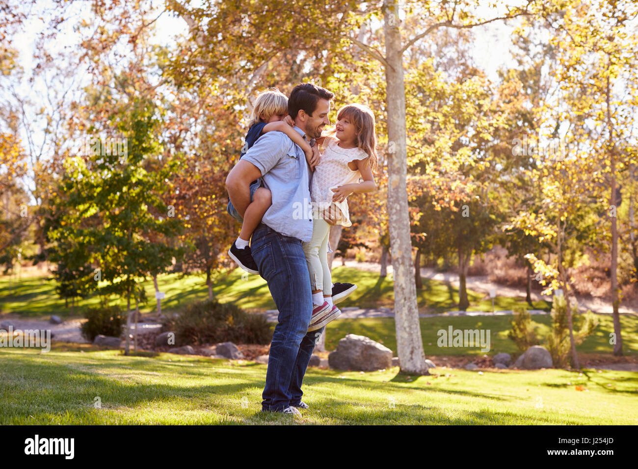 Confident father carrying son hi-res stock photography and images - Alamy