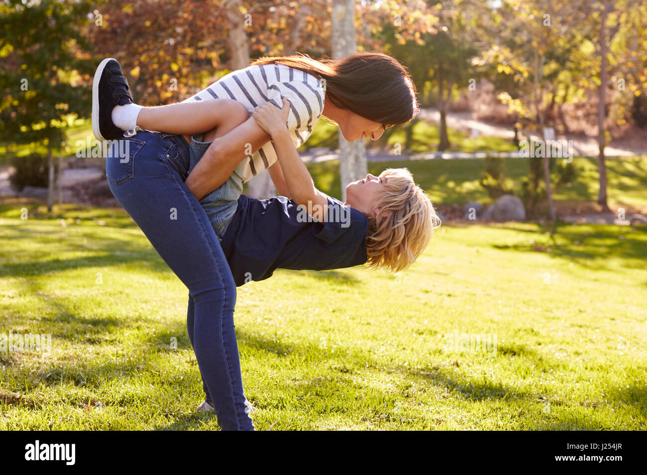 Loving Mother Hugging Son In Park Stock Photo - Alamy