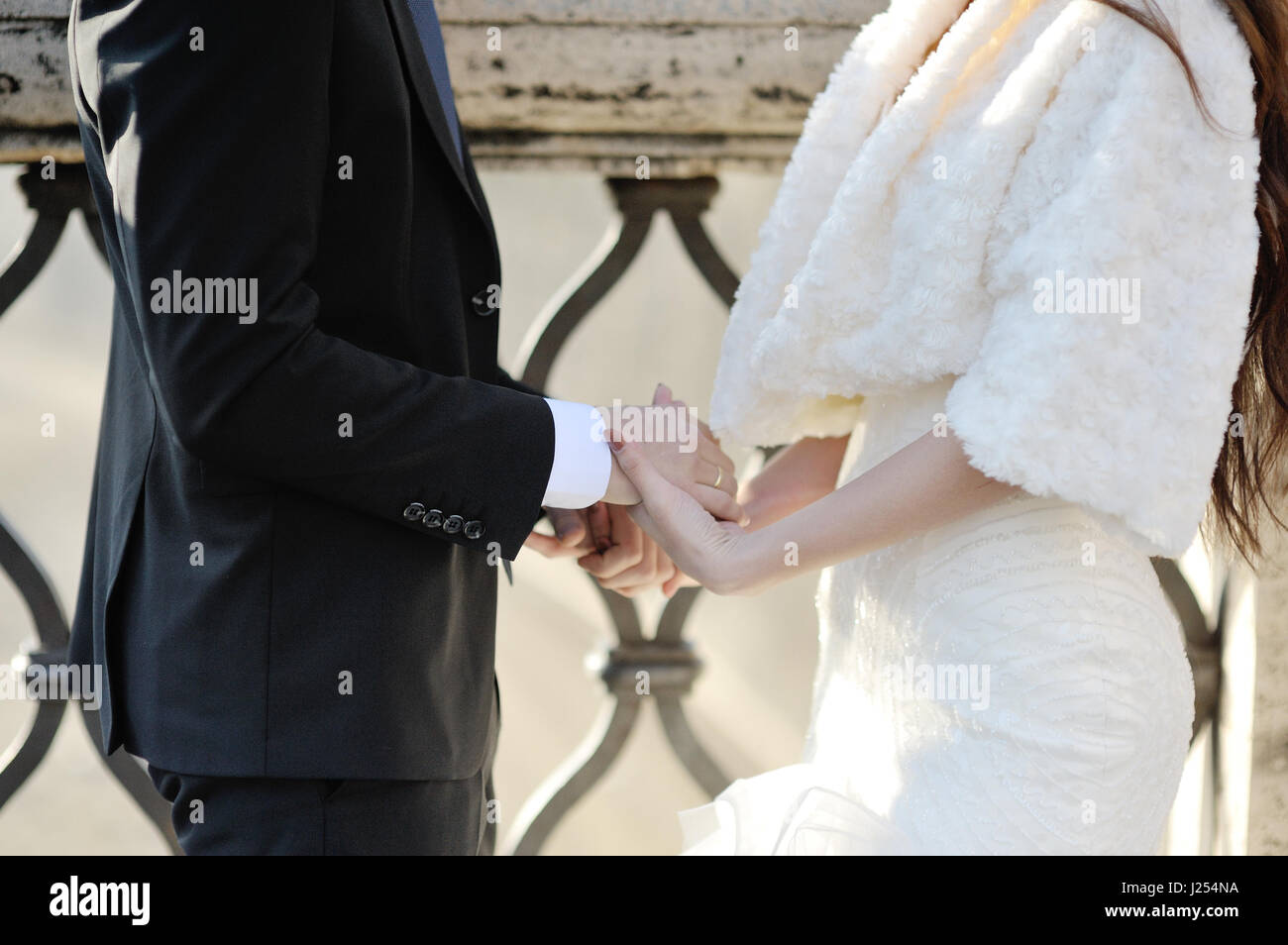 Bride and groom holding hands in wedding day Stock Photo - Alamy