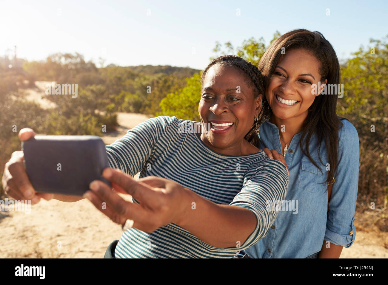 Mother daughter self portrait walking hi-res stock photography and ...