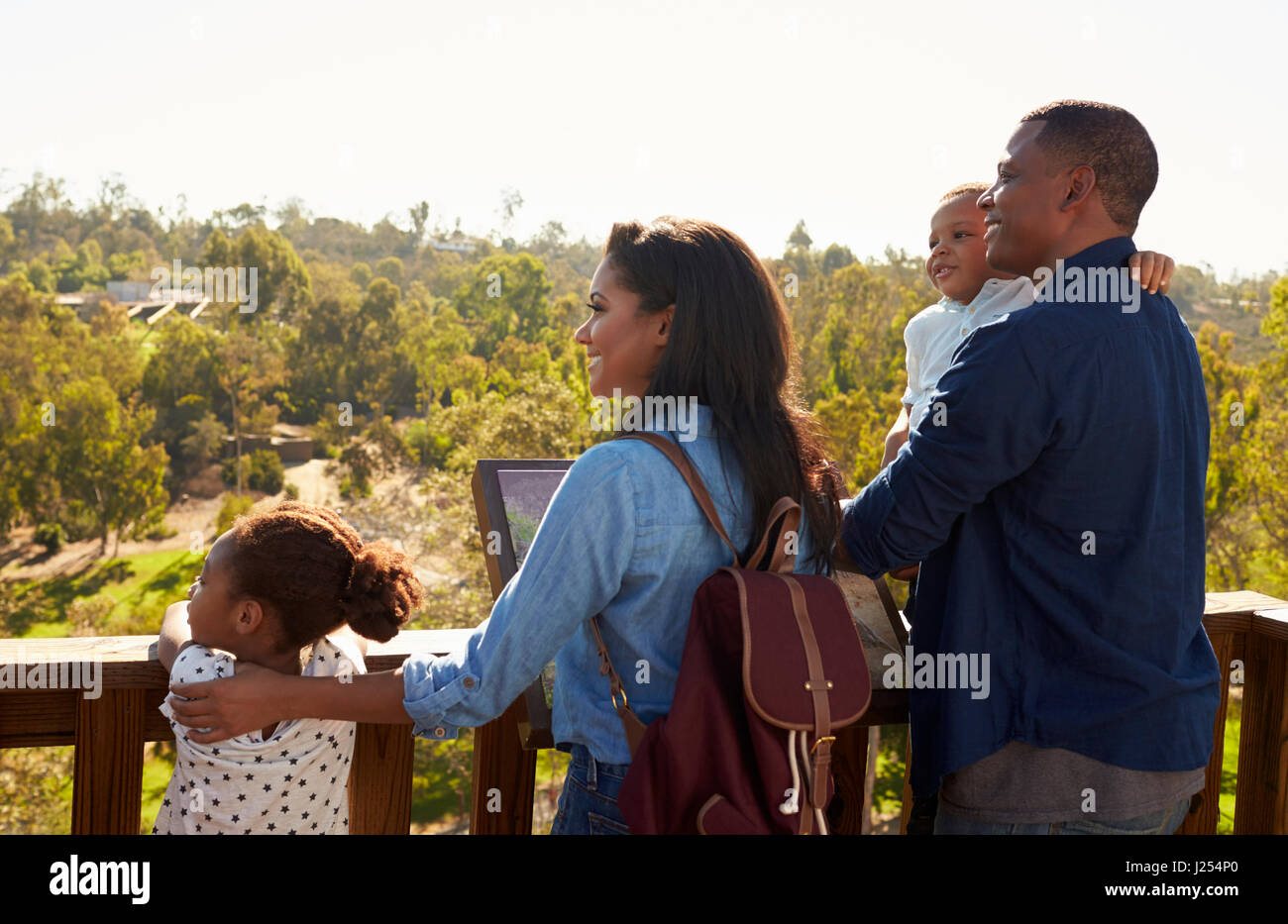 Family Standing On Outdoor Observation Deck Looking At View Stock Photo ...