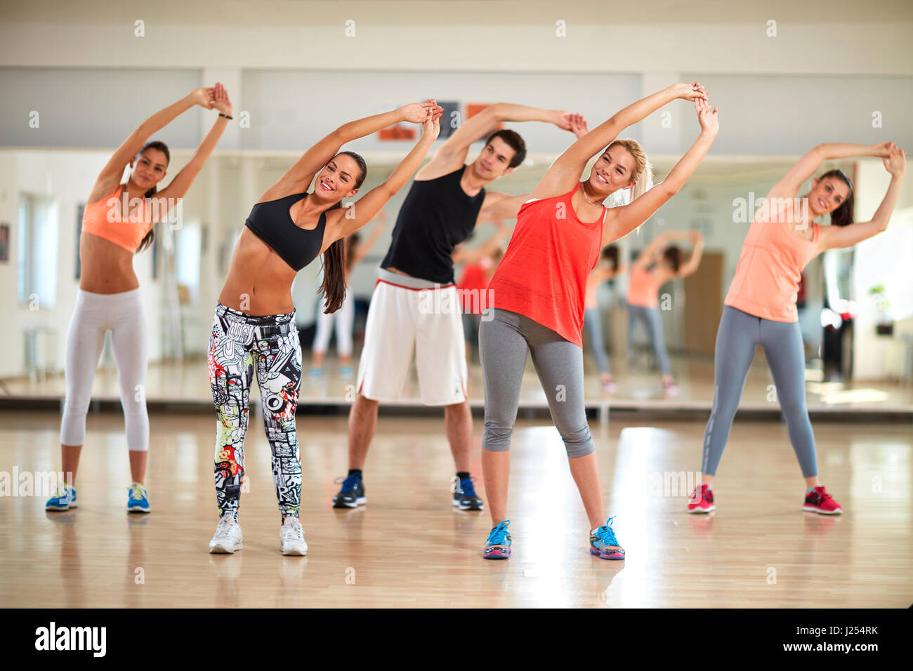 Group of young people on training at gym Stock Photo - Alamy