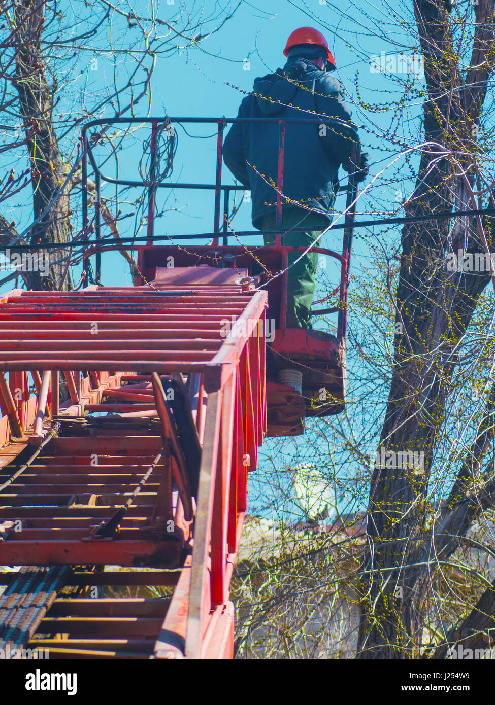 The worker on the red lift machine Stock Photo - Alamy