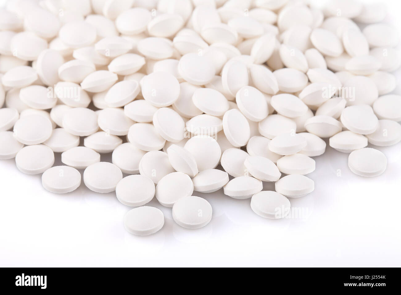 White vitamin D pills on a white surface. Pills isolated on white ...
