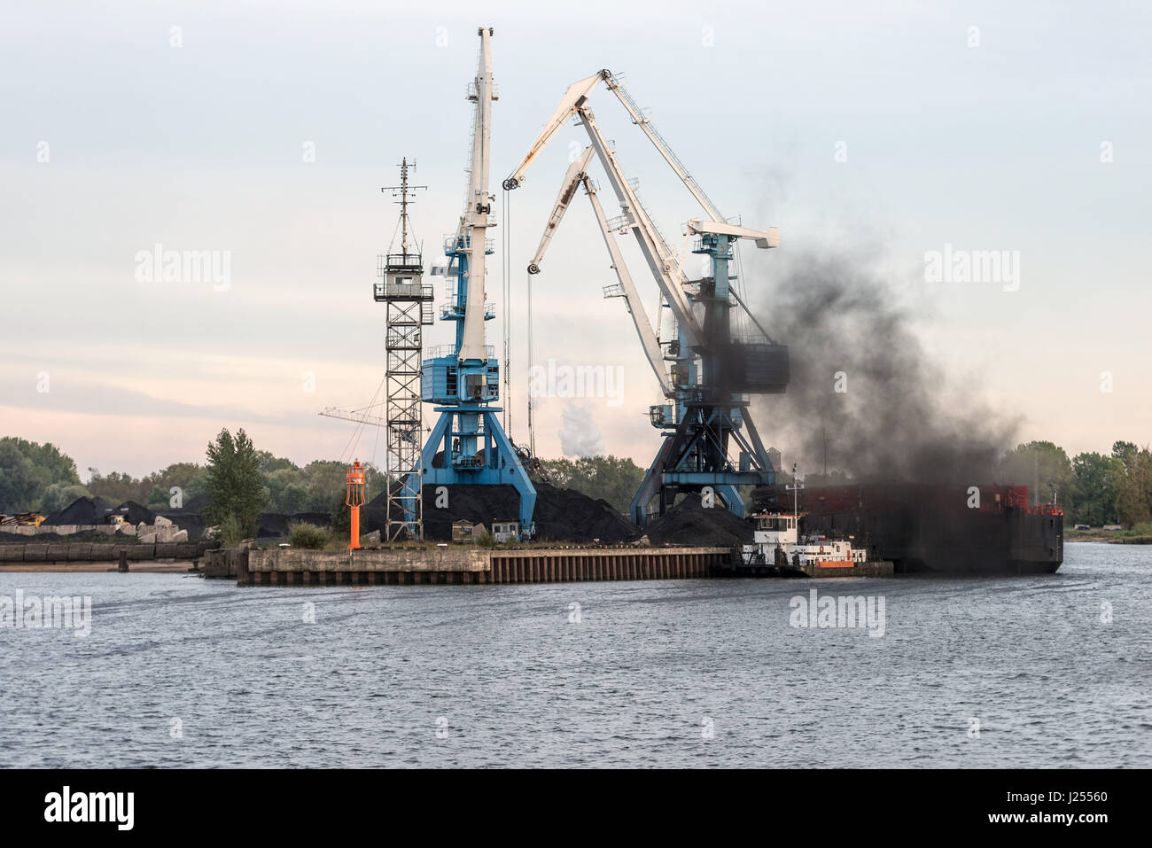 Coal transshipment to container ships Stock Photo - Alamy