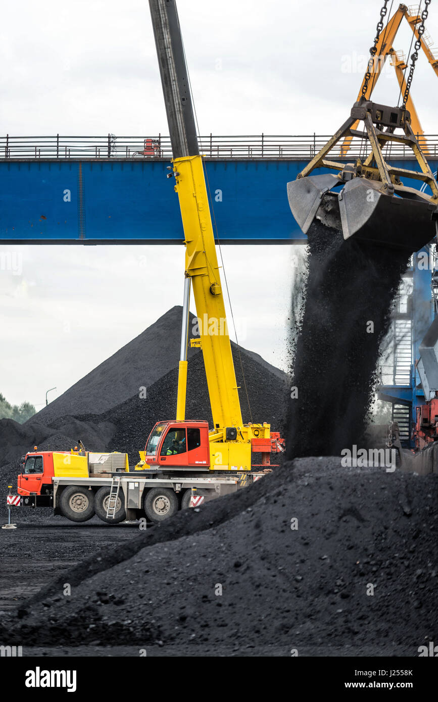 Work in port coal transshipment terminal Stock Photo - Alamy