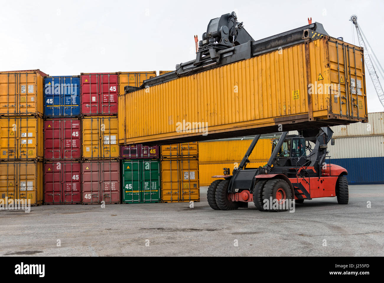 Mobile stacker handler in action at a container terminal Stock Photo ...