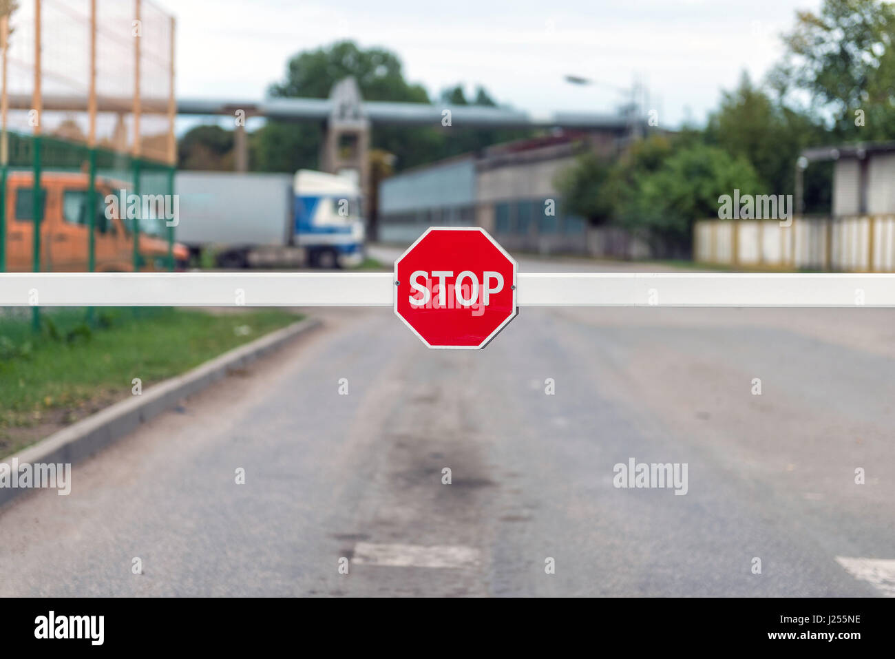 Automatic barrier with a STOP sign Stock Photo - Alamy