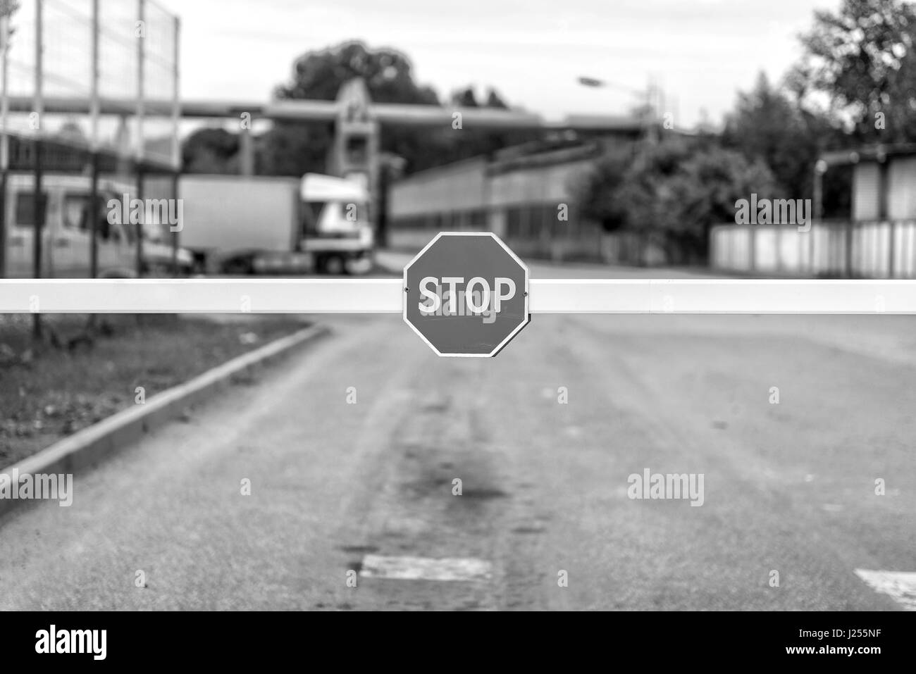 Automatic barrier with a STOP sign Stock Photo - Alamy