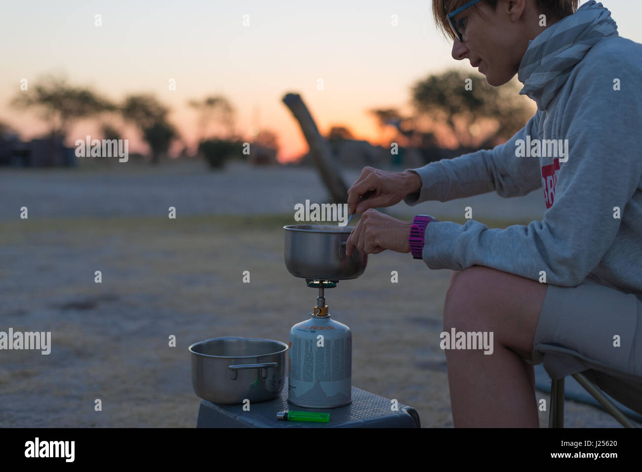 Woman cooking at stove hi-res stock photography and images - Alamy