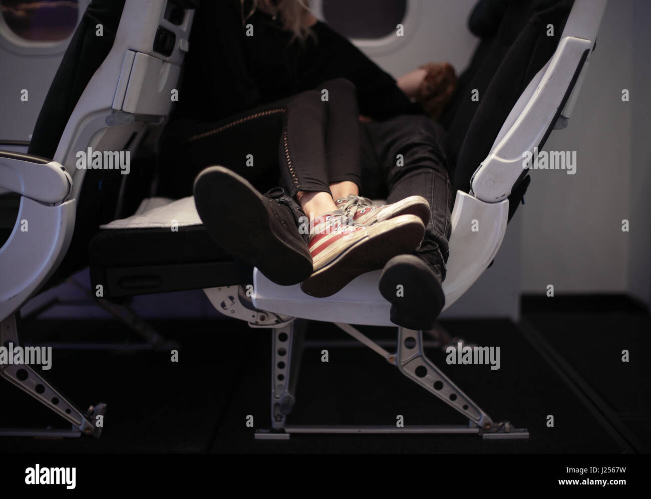 A couple try the Economy Skycouch flexible seating in a mock-up ...