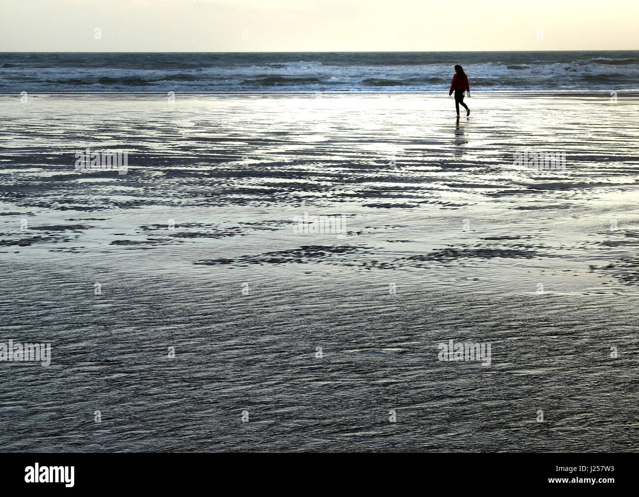Figure walking alone on the beach hi-res stock photography and images ...