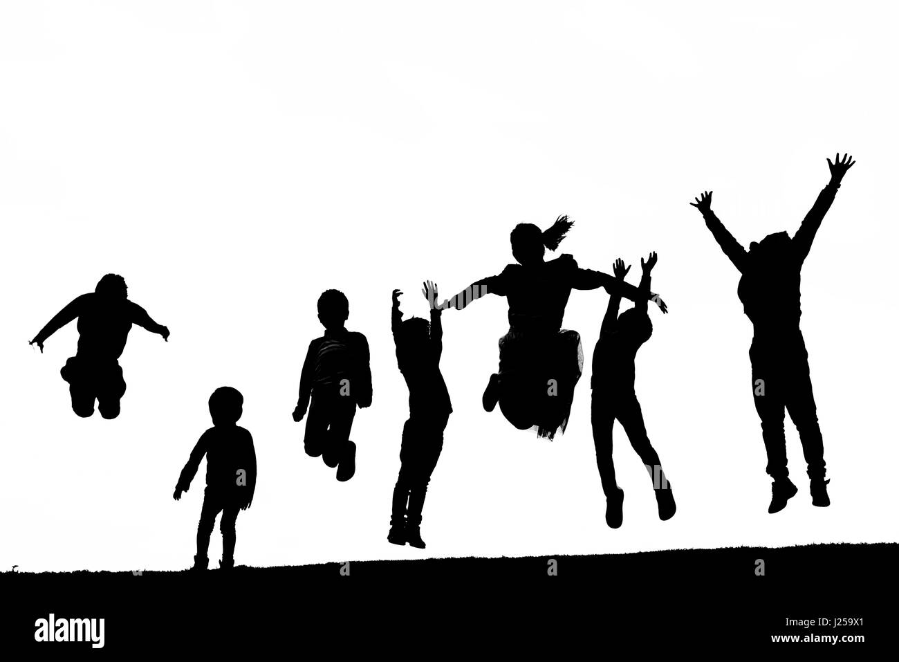 Shadow people playing and jumping on top of the hill Stock Photo - Alamy