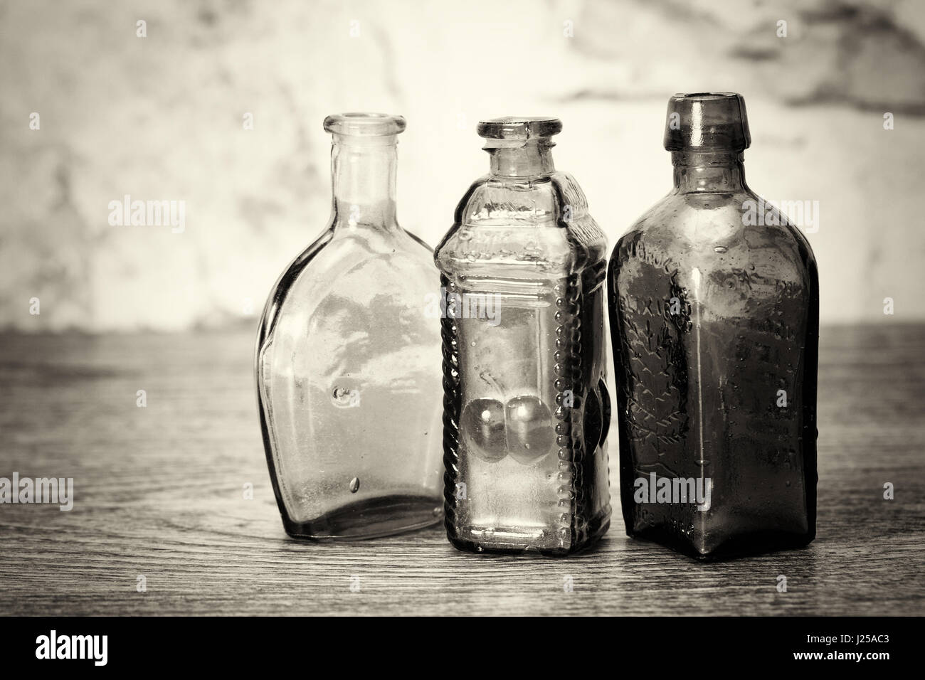 Selection of coloured glass bottles on a rustic background Stock Photo ...