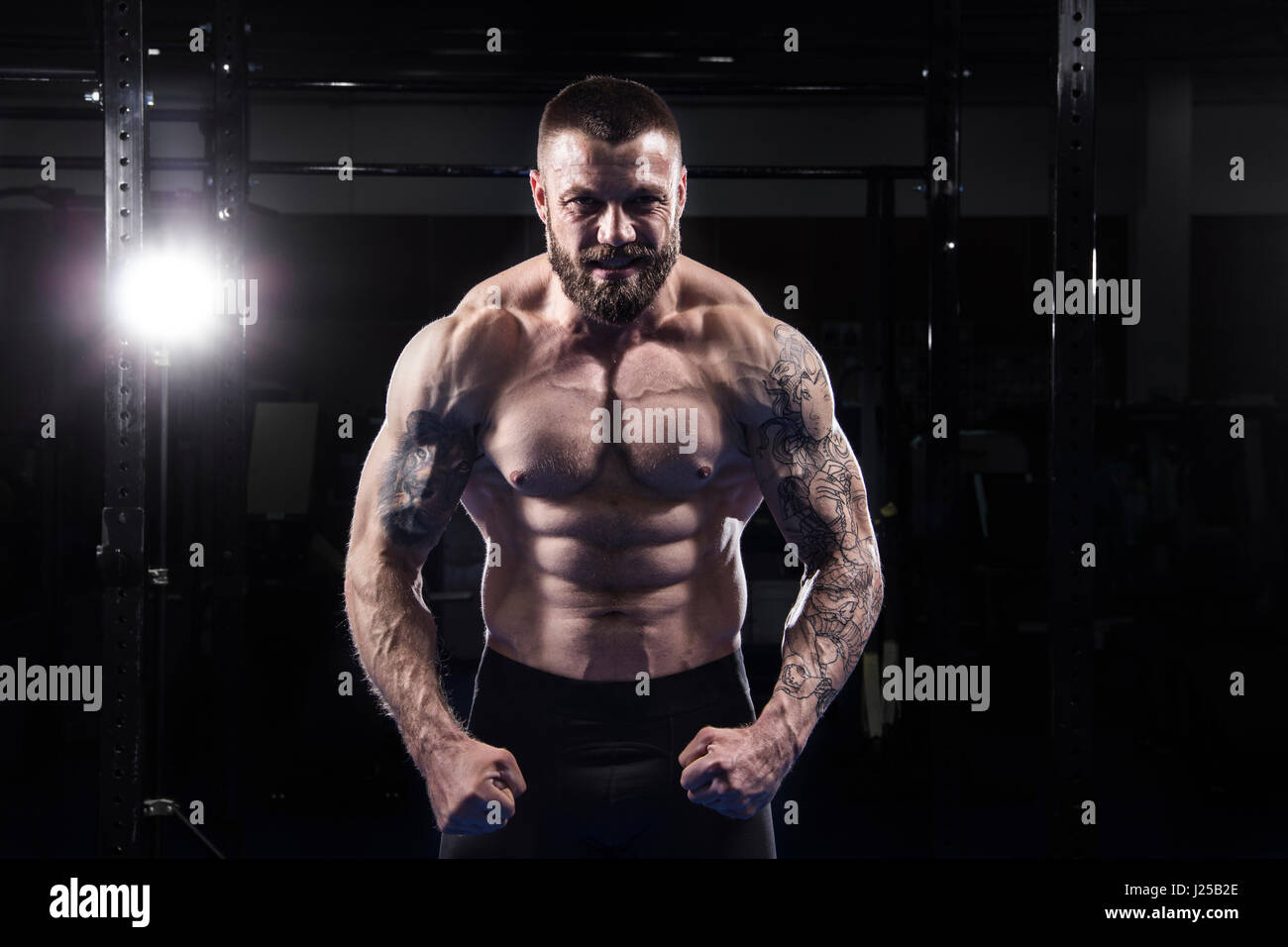 The portrait of brutal muscular athlete preparing and concentratiing ...