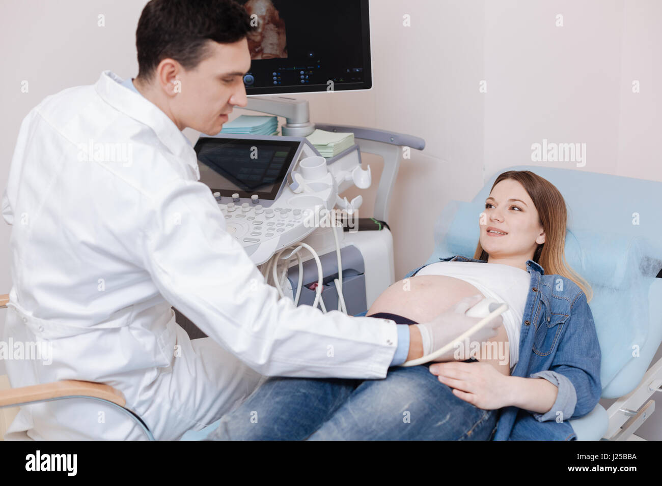 Careful young doctor using ultrasound machine in the hospital Stock ...