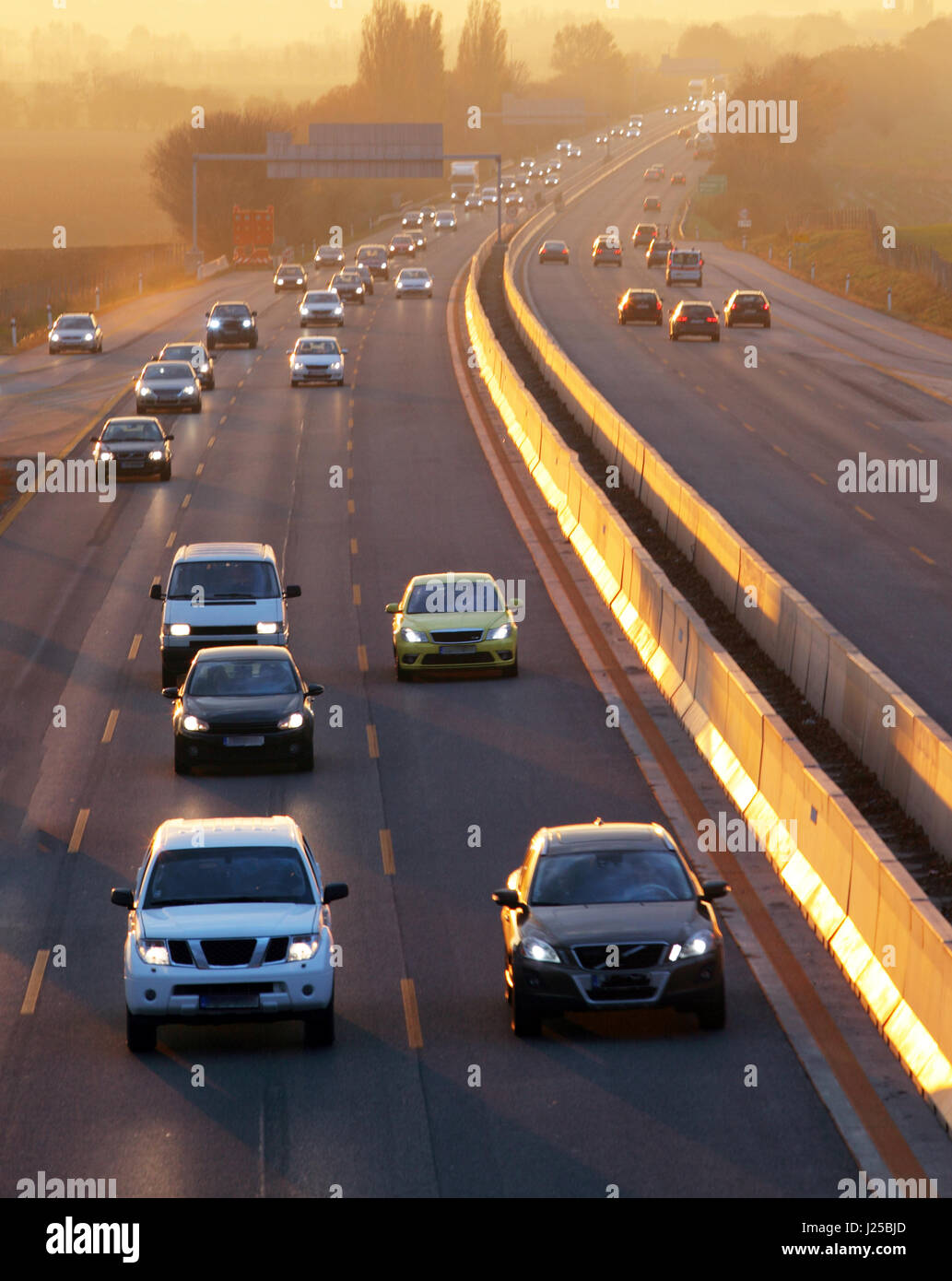 Cars on highway road at sunset Stock Photo - Alamy