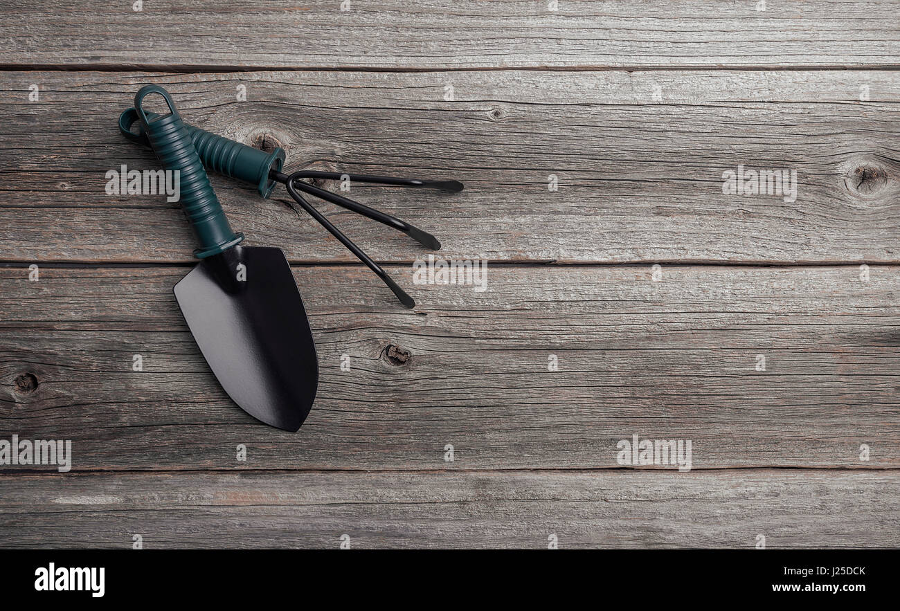 A garden shoulder blade and a rake on a wooden background Stock Photo ...