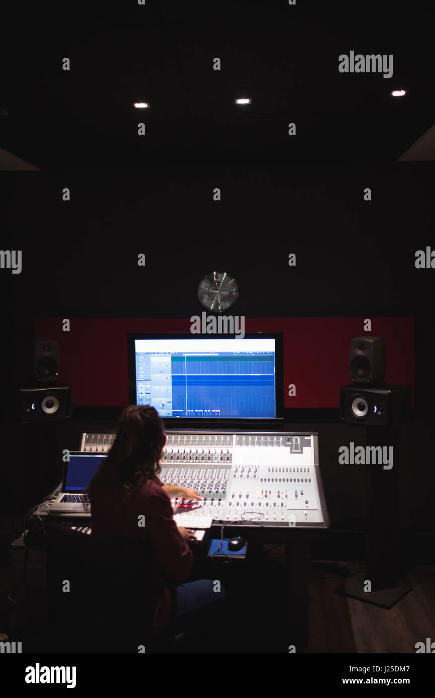 Male audio engineer using sound mixer in recording studio Stock Photo ...