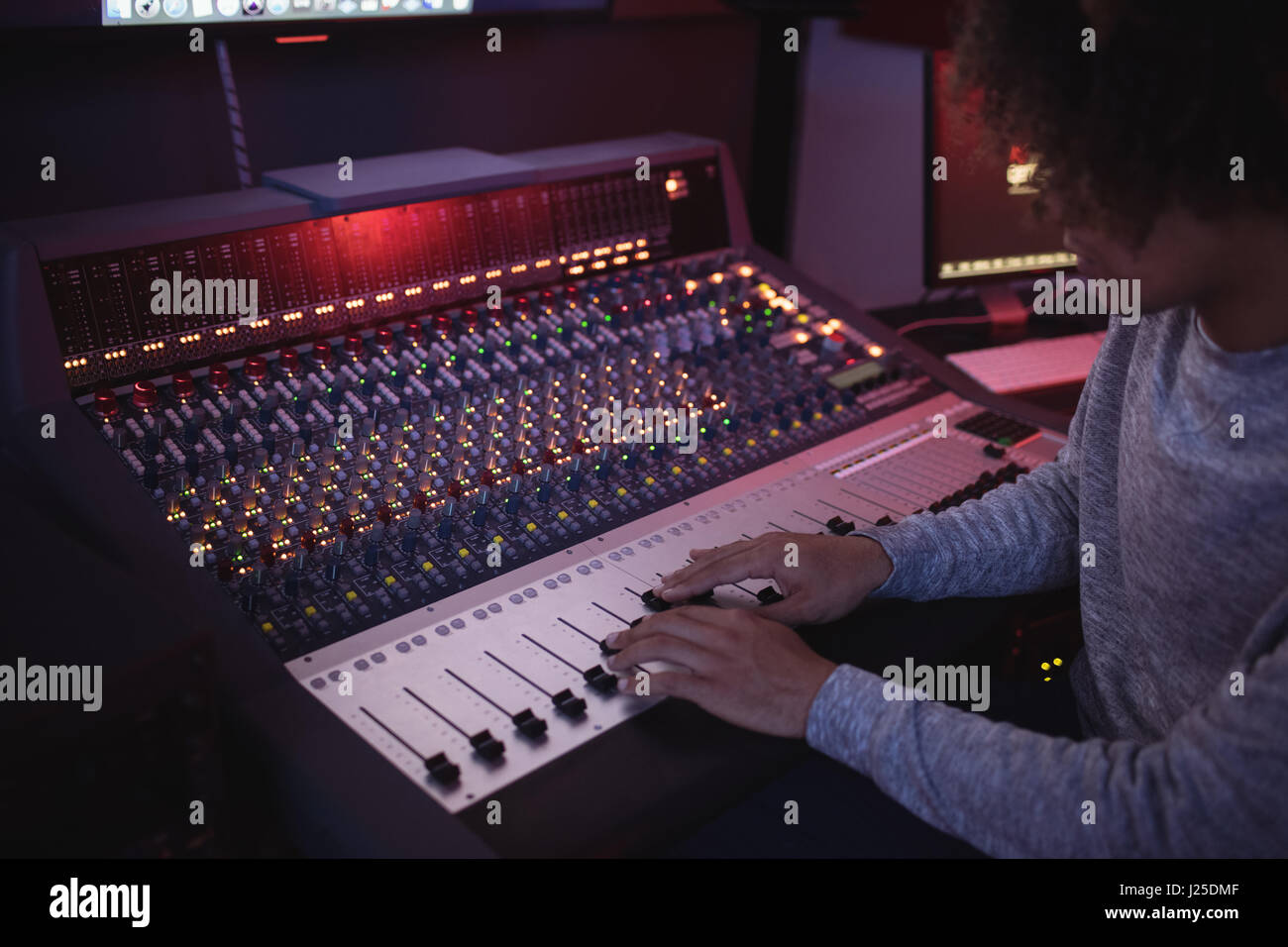Male audio engineer using sound mixer in recording studio Stock Photo ...
