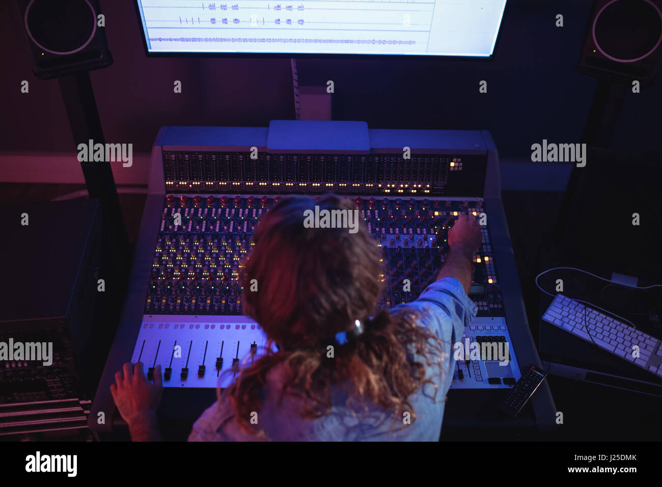 Male audio engineer using sound mixer in recording studio Stock Photo ...