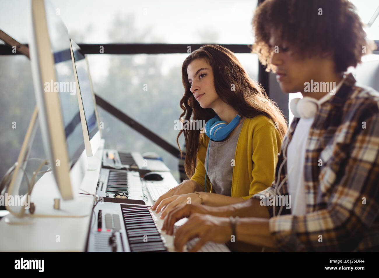 Audio engineer playing electric keyboard in recording studio Stock ...