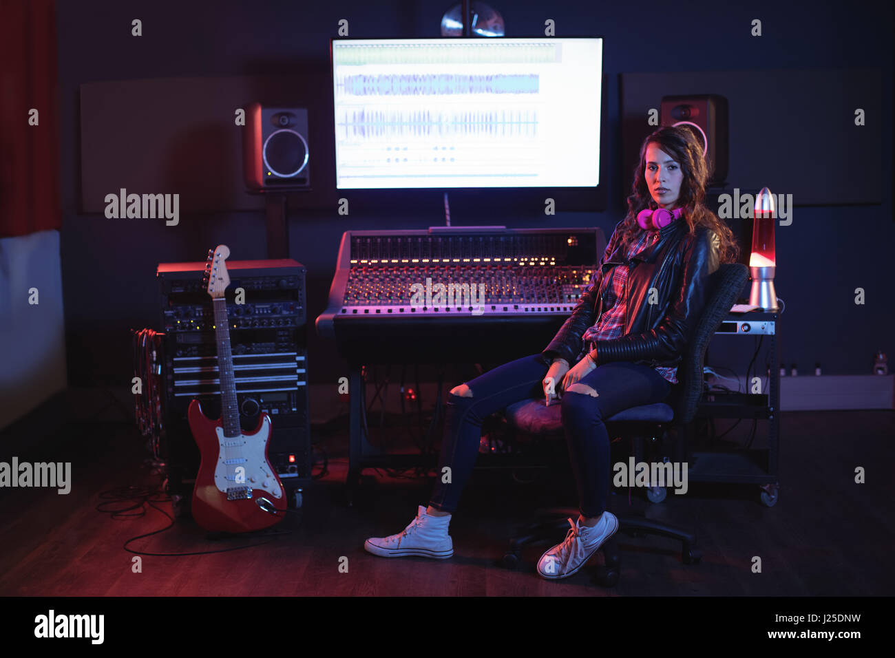 Portrait of female audio engineer sitting in recording studio Stock ...