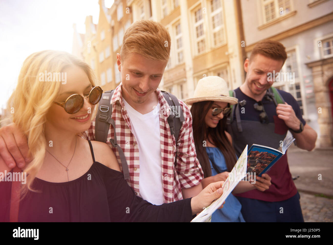 Group of friends looking for interesting places Stock Photo - Alamy