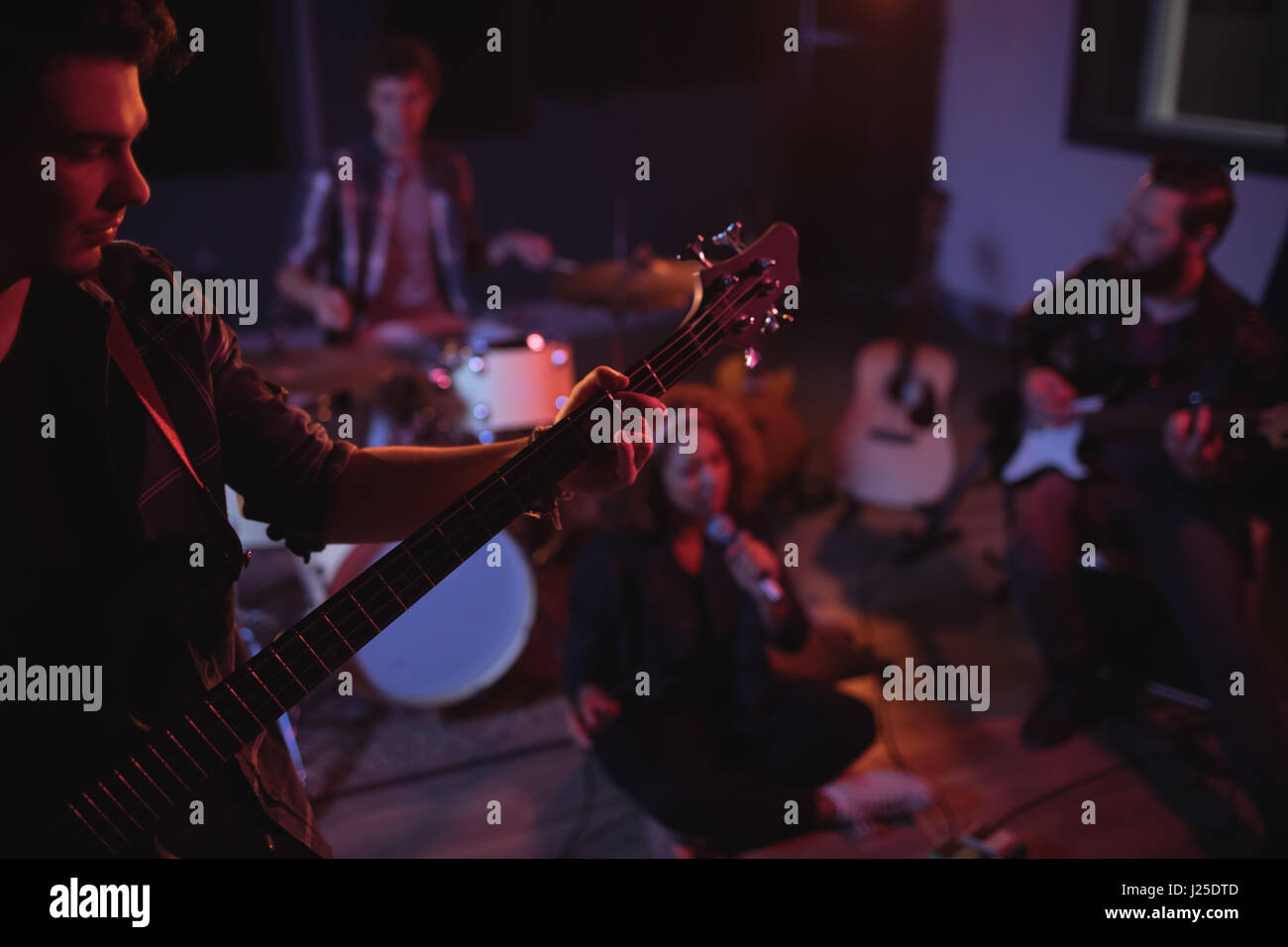 Band mates performing together in recording studio Stock Photo - Alamy