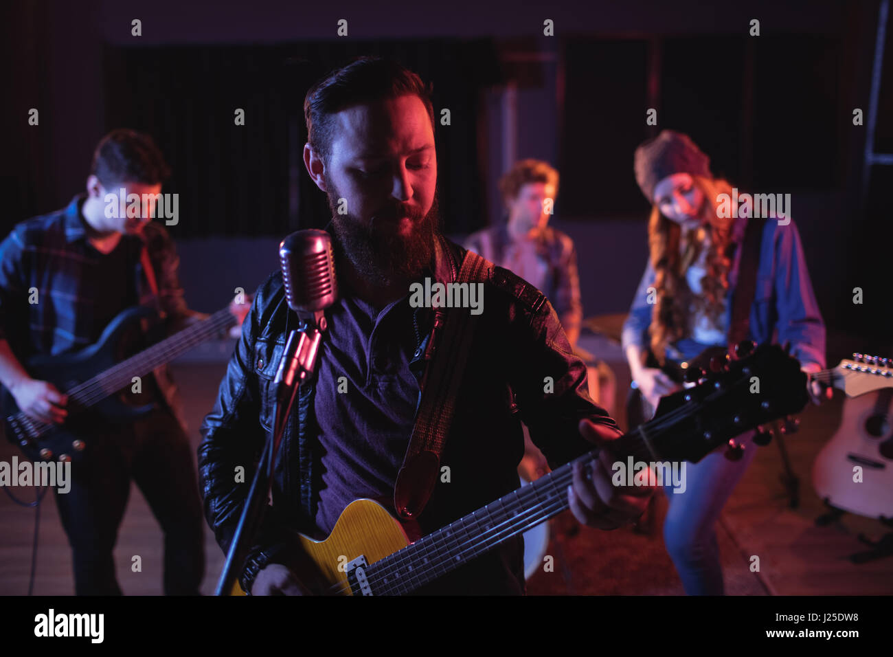 Band mates performing together in recording studio Stock Photo - Alamy