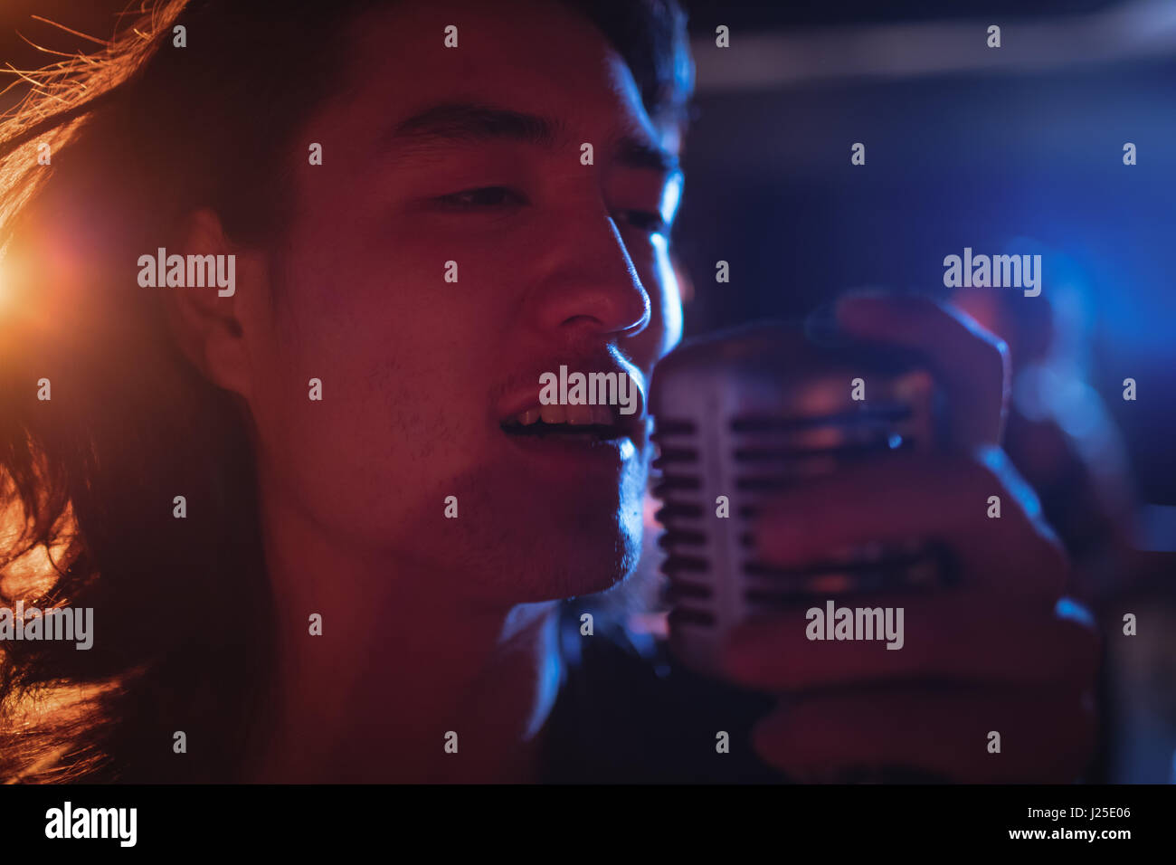 Close-up of male singer singing in recording studio Stock Photo - Alamy